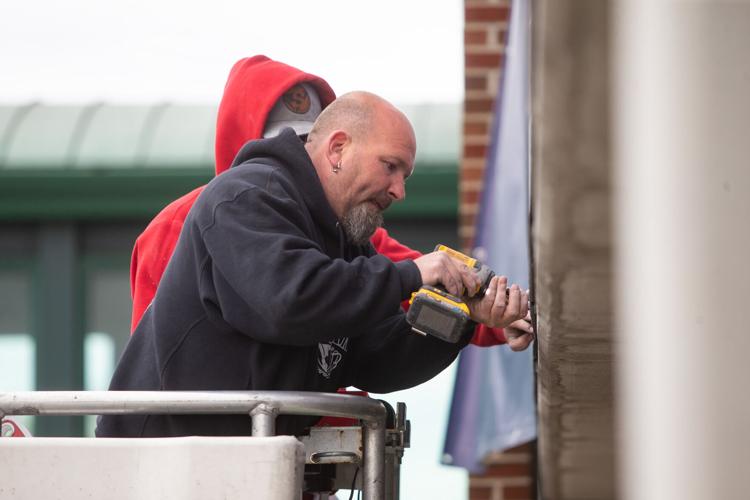 Don't look down: Employees add signage to Marshall parking garage ...
