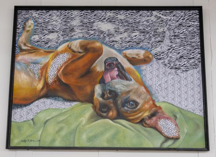 Gallery and frame shop operator Carolyn Dameron Riddle points her brush ...