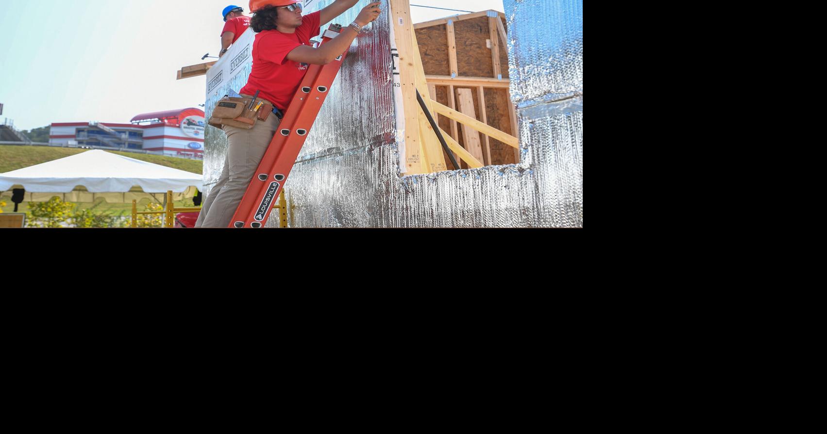 Two local families watch their new homes built at the track