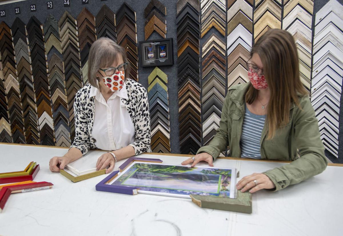 Gallery and frame shop operator Carolyn Dameron Riddle points her brush ...