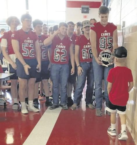 Marion High football team makes a special memory for young fan