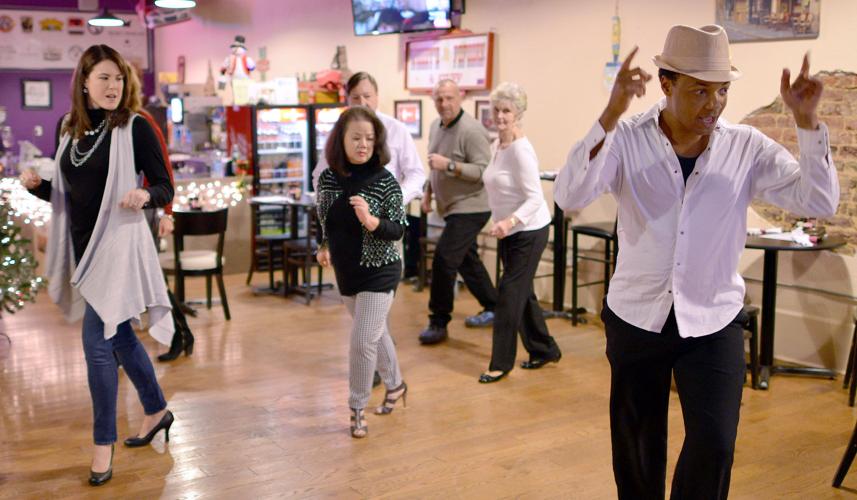 Couples enjoy dinner and dance lessons at downtown cafe
