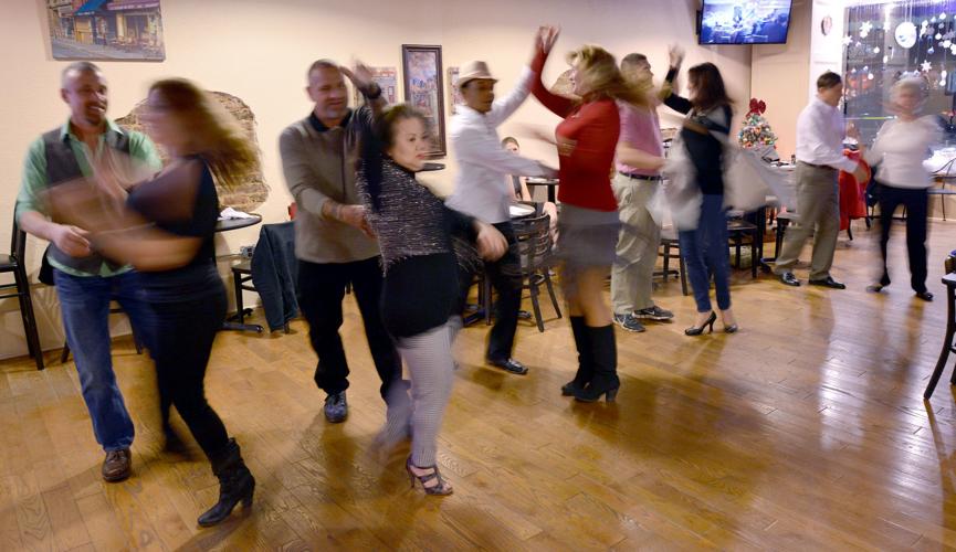 Couples enjoy dinner and dance lessons at downtown cafe