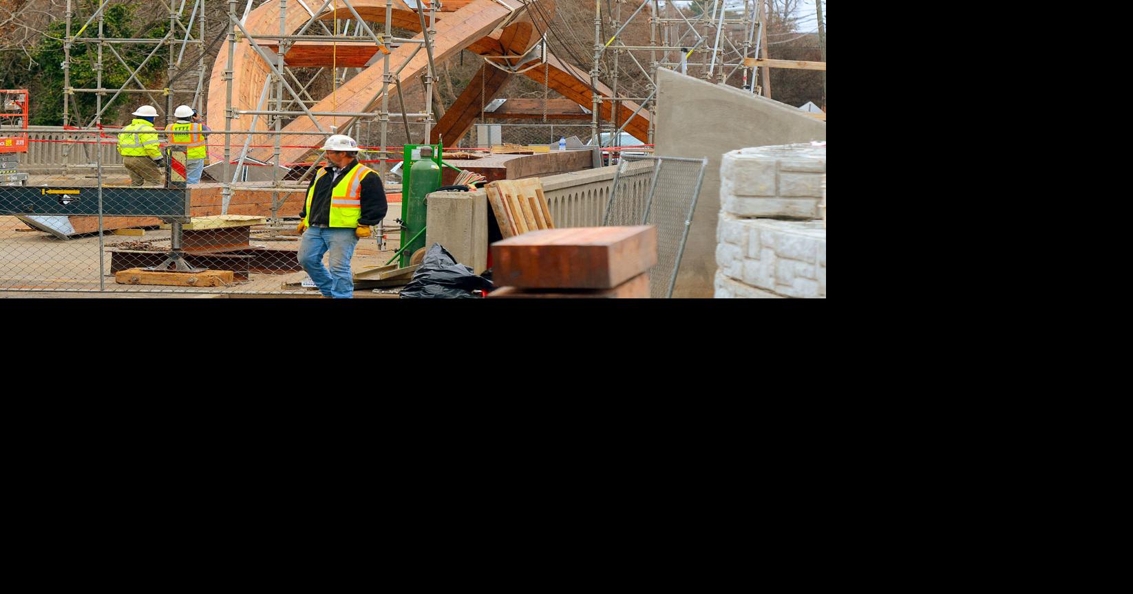 Workers assemble arches for pedestrian bridge in Hickory