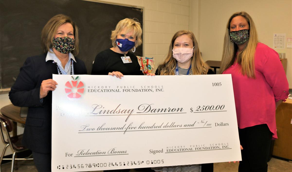 Teacher receives relocation check from foundation