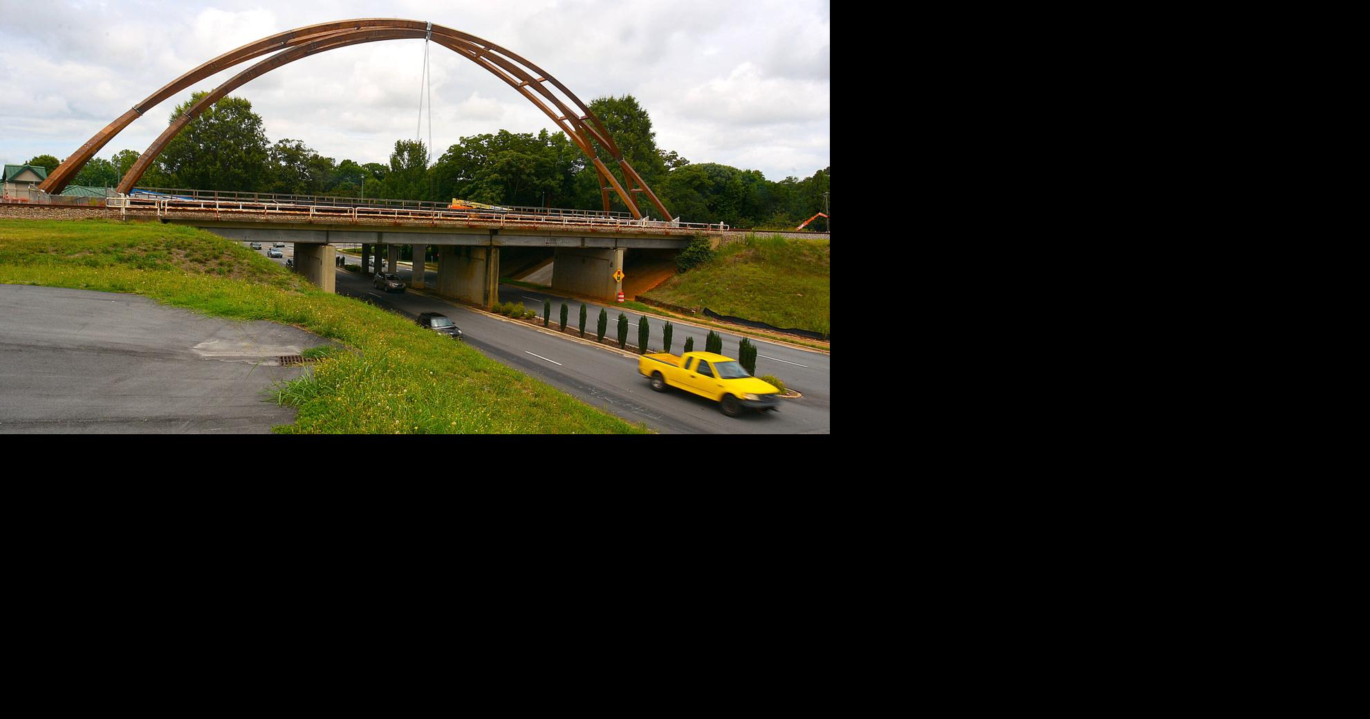 Workers complete arch installation; attention turns to finishing rest ...