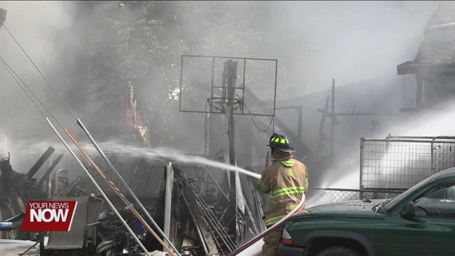 Crews battle two-alarm fire at the corner of W. Fifth and McClain in ...