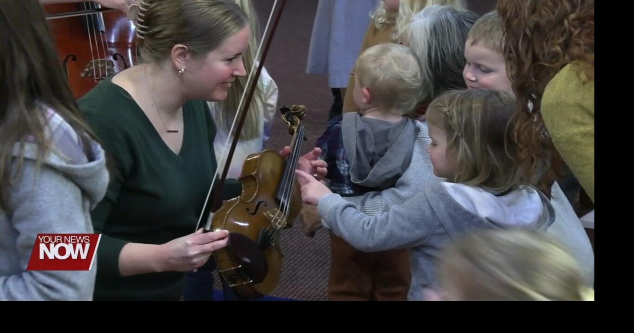 Young children learn about string instruments at Symphony Storytime ...