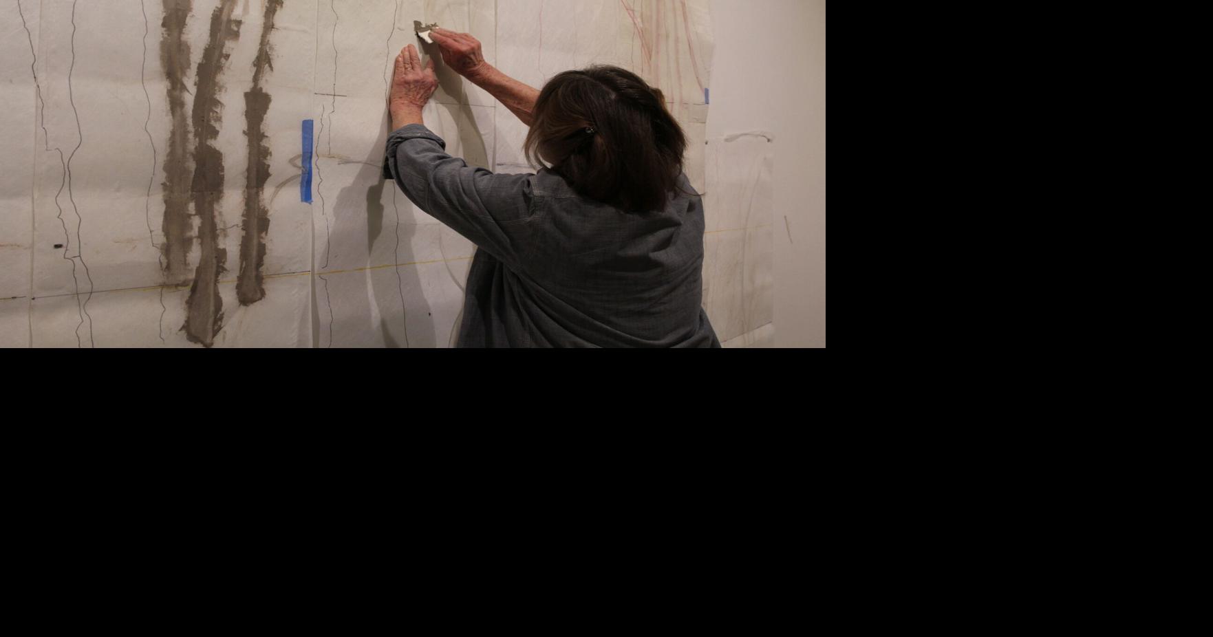 Teri Power prepares her work with natural clay and sketches. Power ...