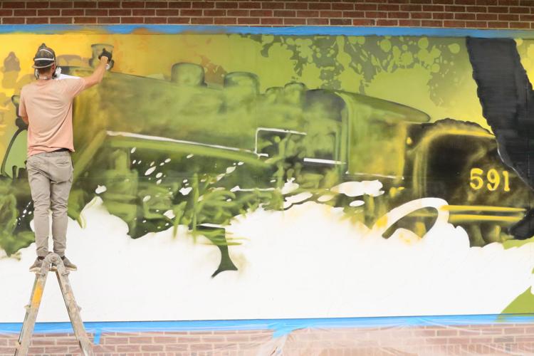 Street art muralist paints Greenwood-inspired art near Uptown Market ...