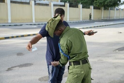 Security was tight, with police searching voters at polling stations ...