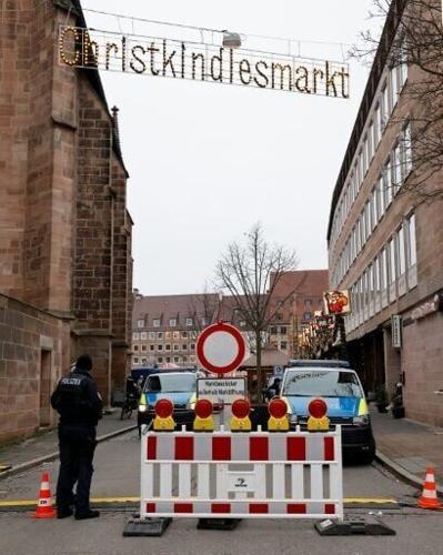 German police guard a street leading to the Christmas market in ...