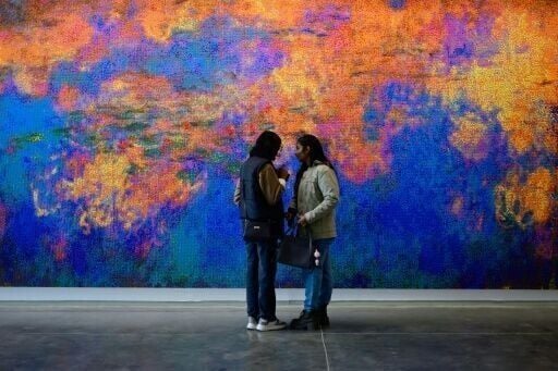 Visitors look at an artwork titled "Water Lilies" by Chinese artist Ai ...