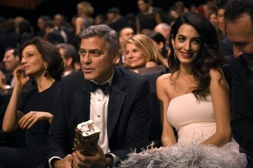 Actor George Clooney, who admits his French is 'bad', and wife Amal ...