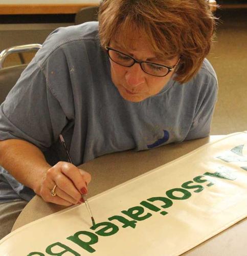 Kiel River Walk District's volunteers paint banners | Archives ...