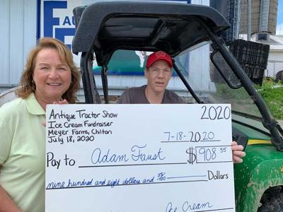 Adam Faust receives a check in the amount of $908.55 from Sue Brown ...