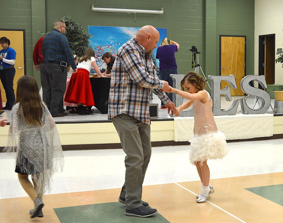 Daughtry Elementary brings Parisian theme to daddy-daughter dance ...