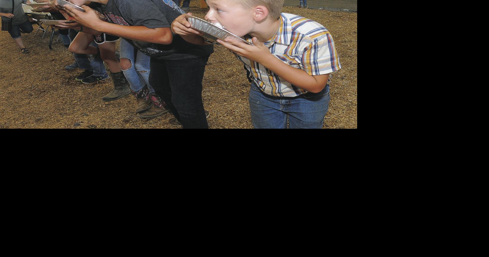 Cow Pie Eating Contest, Pig Calling Contest held at youth fair ...