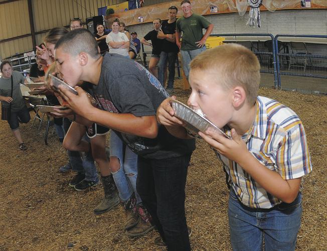 Cow Pie Eating Contest, Pig Calling Contest held at youth fair ...