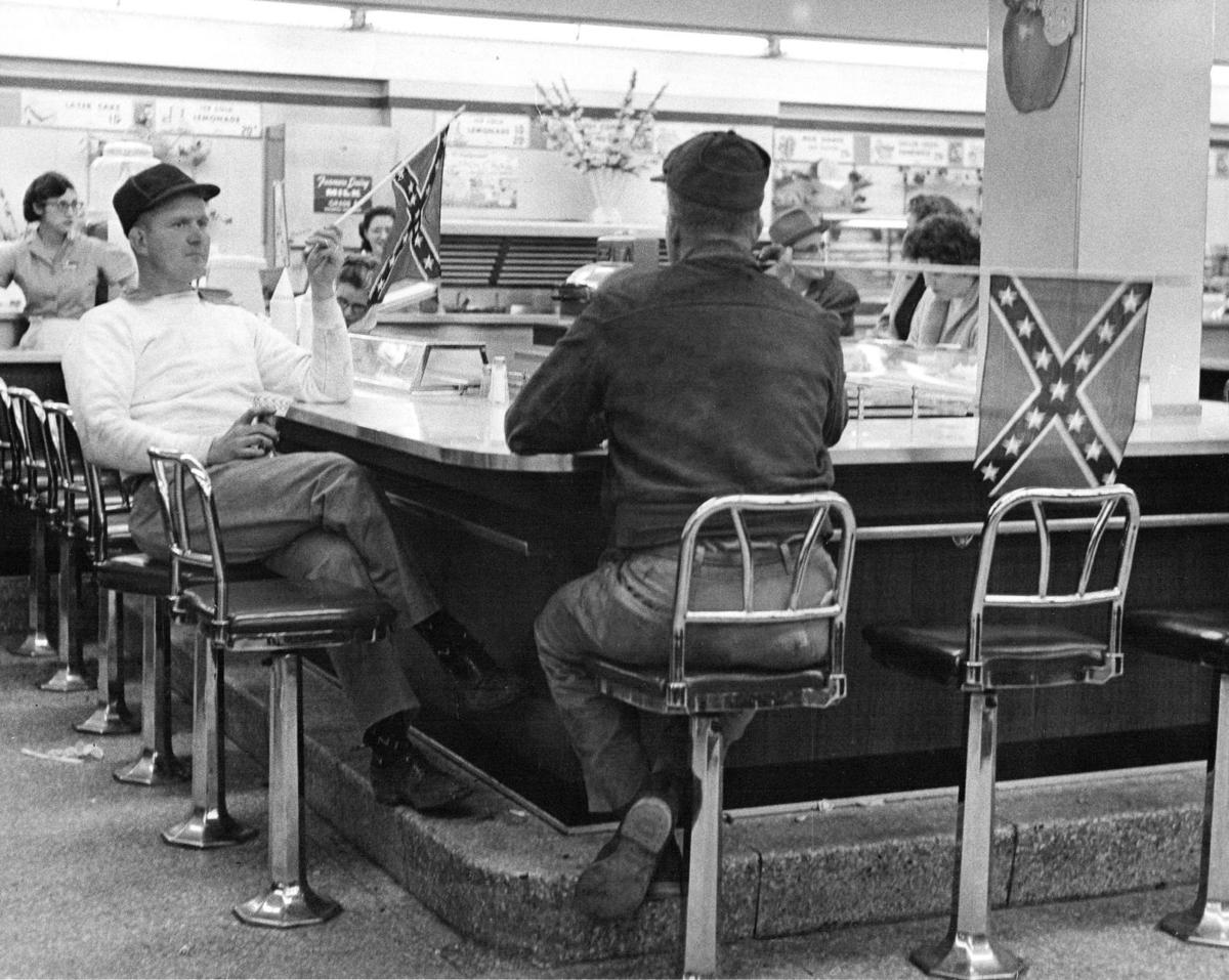 Twenty-two black and white local college students staged a sit-in ...
