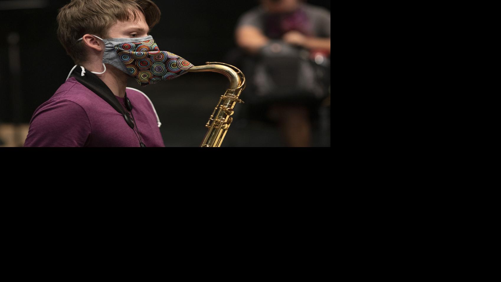 Musicians improvise masks for wind instruments to keep the band ...