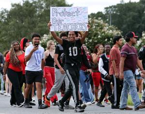 Forsyth County students stage walkout to protest job cuts