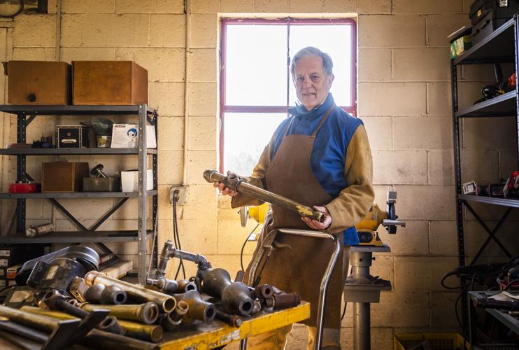 Local sculptor Duncan Lewis does welded metals he calls “industrial ...