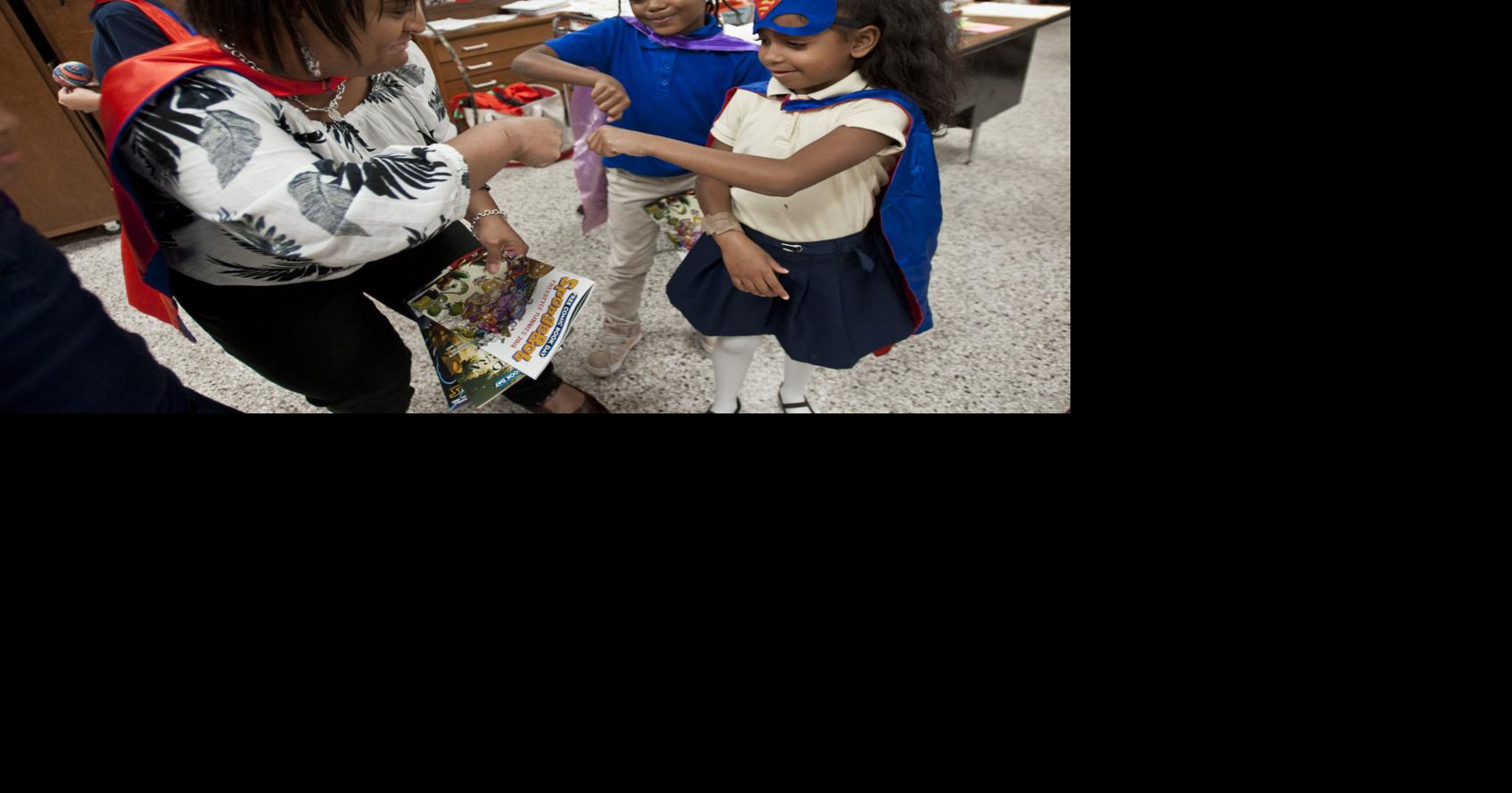 Superheroes deliver comic books to Griffith Elementary
