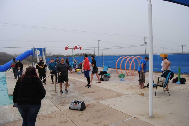 Taking the plunge: Cove residents jump into pool on chilly morning ...