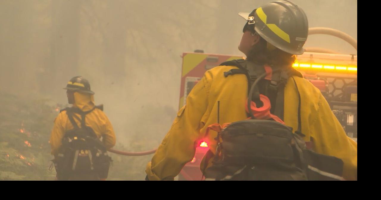 Fire crews fight fire with fire as they work to establish a fire line ...