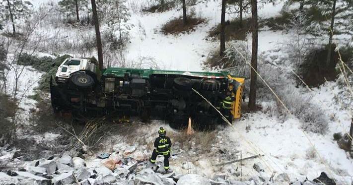 Garbage truck rolls down embankment near Hangman Valley Golf Course ...