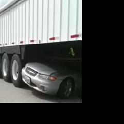 Car pinned under semi trailer, driver escapes serious injury | Spokane ...