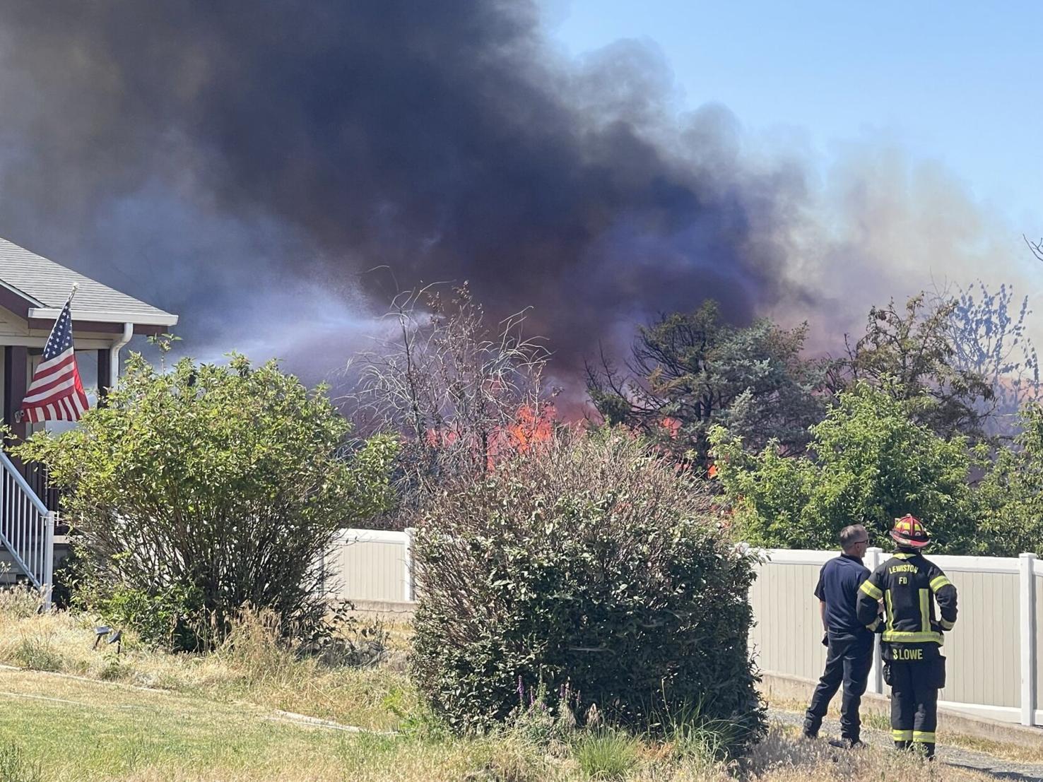 Fire crews battle Clarkston house fire spreading to field | Spokane ...