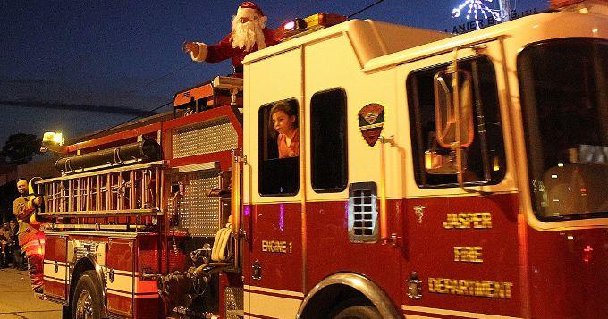 Santa Claus rides into Jasper atop a fire engine in the Christmas ...