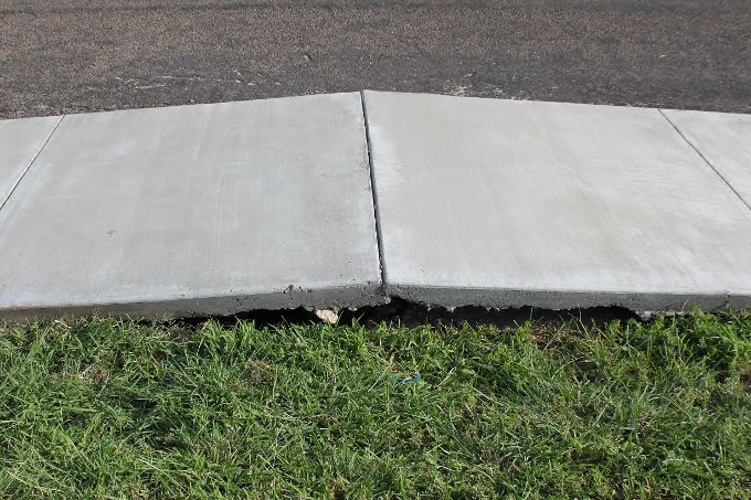 New concrete sidewalk buckles: Who is responsible? | Local News | kjas.com