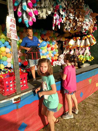Popcorn, cotton candy and candy apples as a carnival visits the rodeo ...