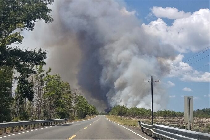 Large woods and grass fire burns on the Louisiana side of Sabine River ...