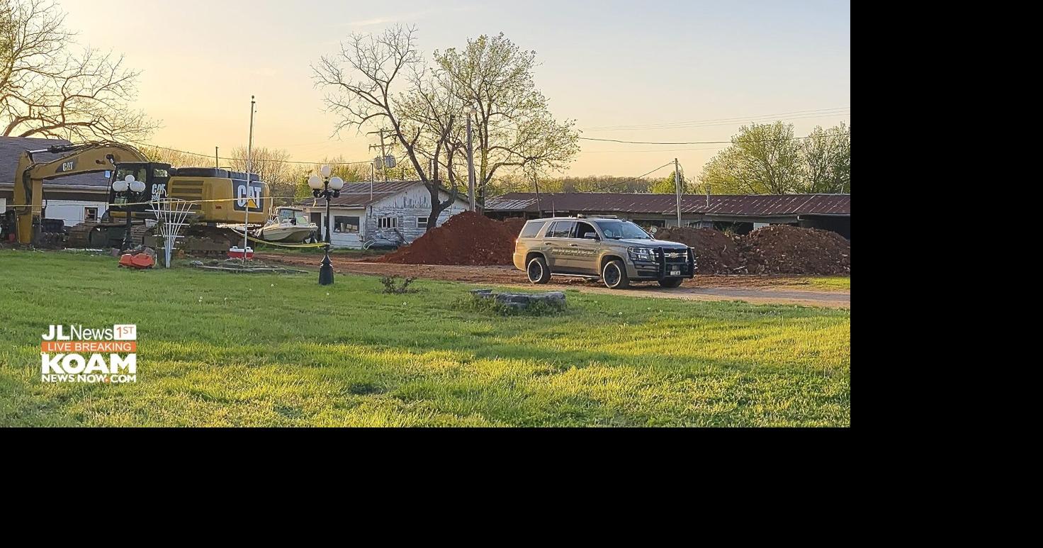 Crime scene tape, active dig operation with heavy equipment; Sheriff ...