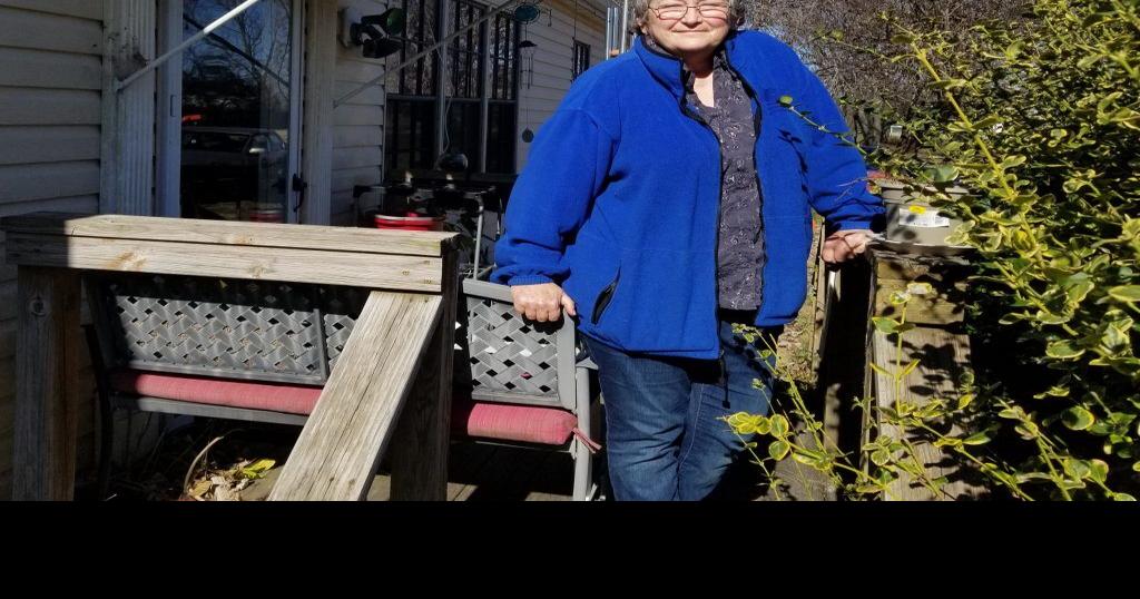 Rebecca Varney stands in November 2020 on the porch of her home in ...