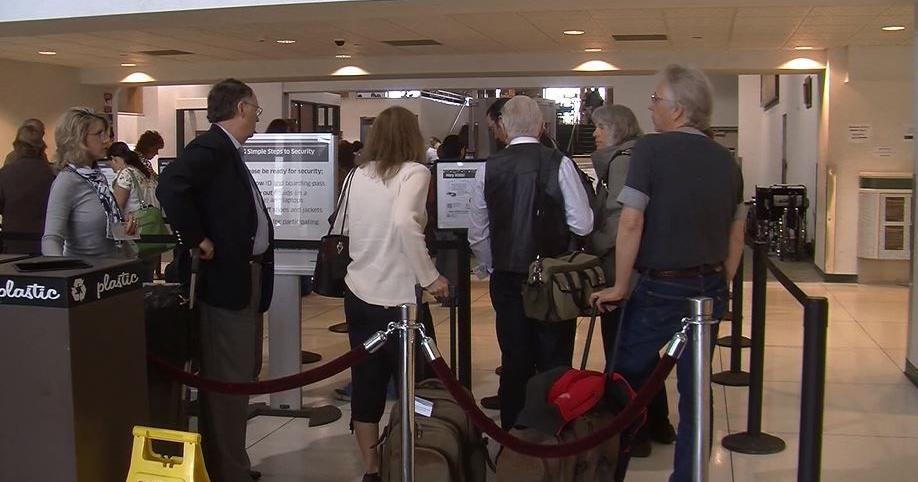 Travelers encouraged to arrive early as staffing shortages cause long ...