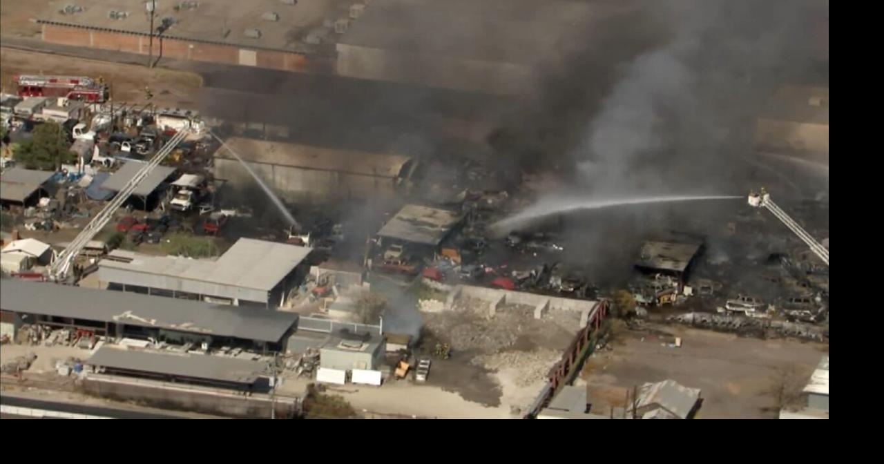 Firefighters working to contain massive junkyard fire burning in ...