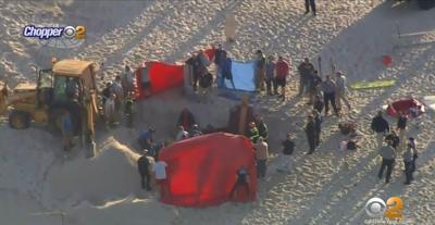 Police: 18-year-old dies after hole in sand collapses on beach in New ...