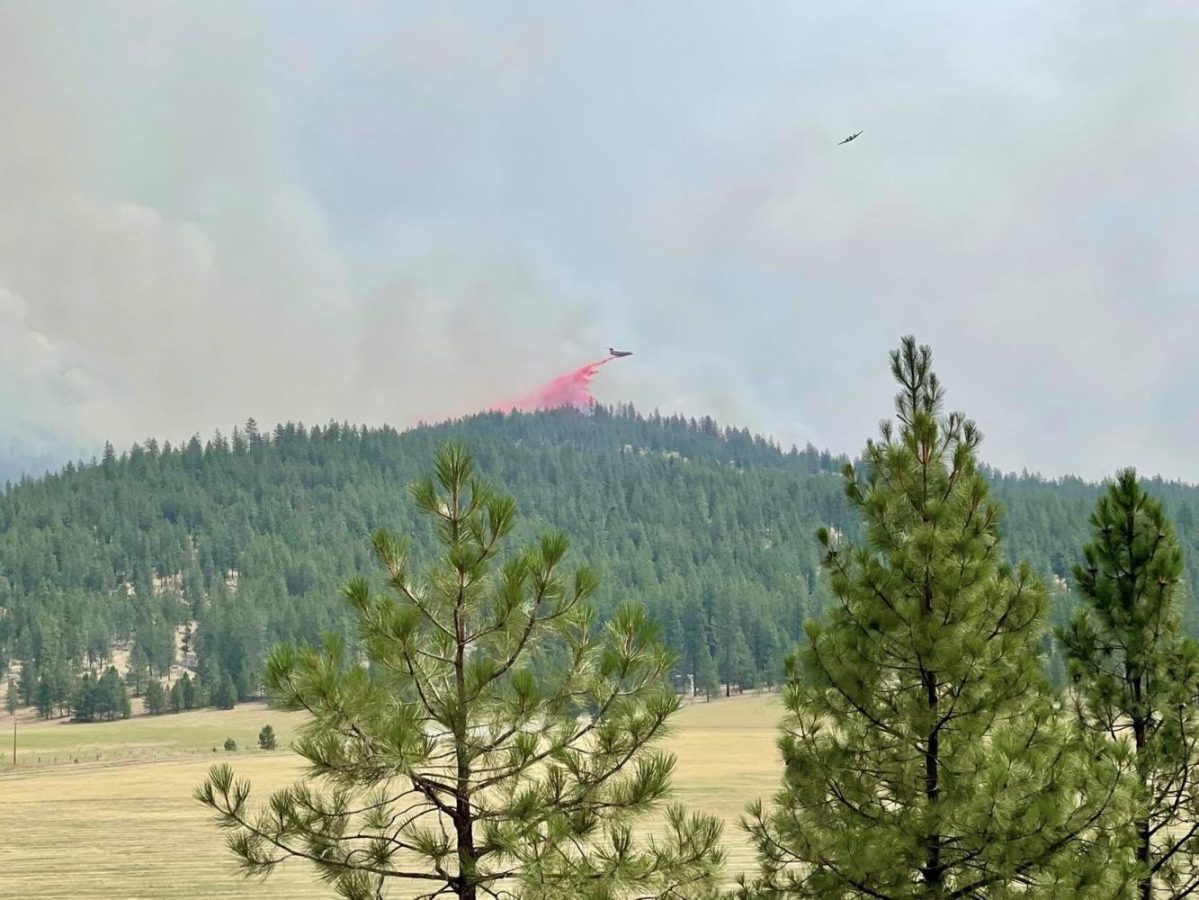 More areas evacuated as crews battle Lake Spokane fire from the ground ...