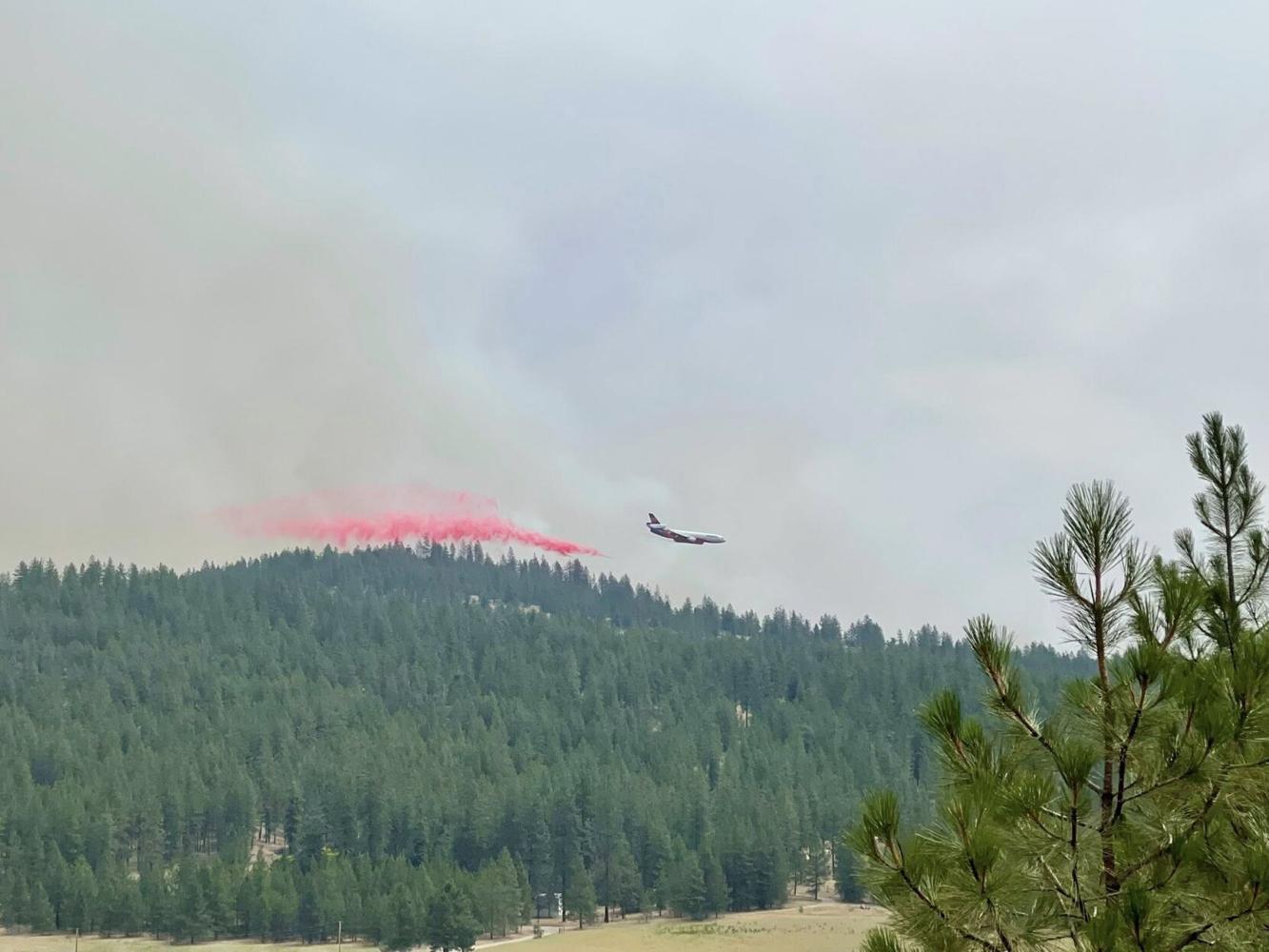 More areas evacuated as crews battle Lake Spokane fire from the ground ...