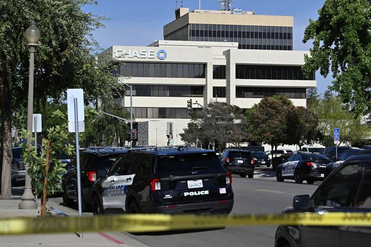 Two hostages are released, but standoff with man after bomb threat at ...