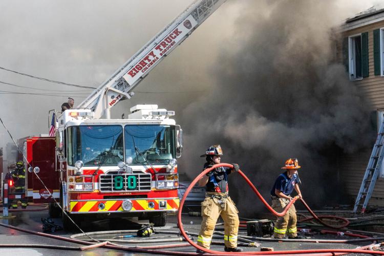 Fire crews battle 3-alarm fire that tears through block of downtown ...