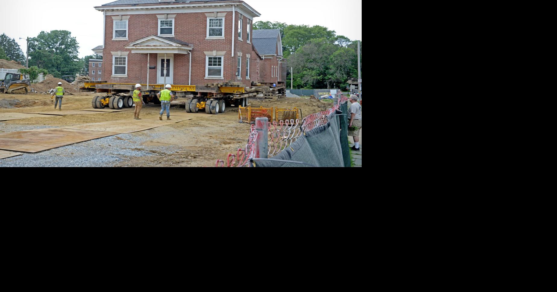 Crews start moving historic carriage house to new location on former ...