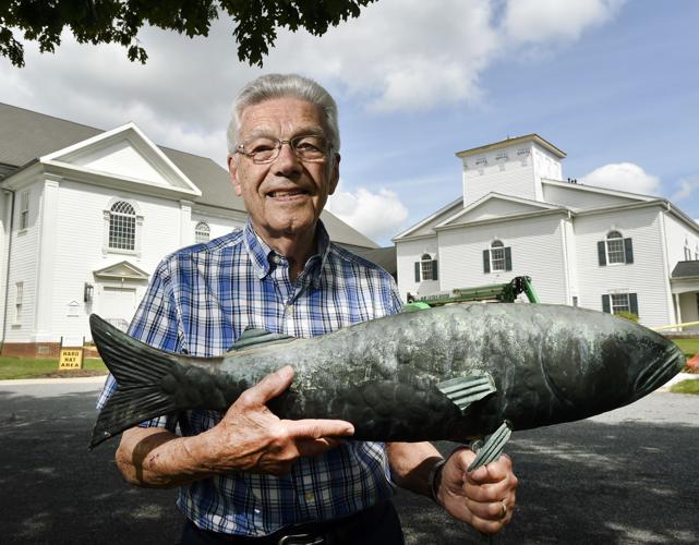 88-year-old Anson Loose reprises his role by placing a fish weather ...