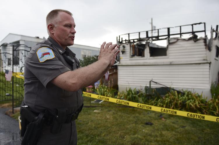 Police officer saves woman from mobile home fire before oxygen tanks ...