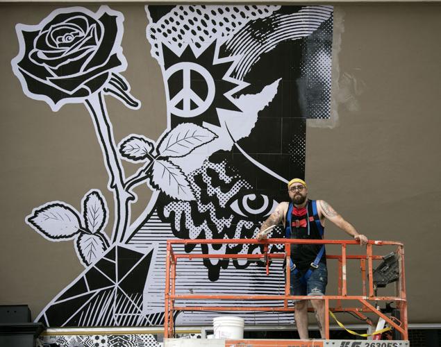 Adam Serrano working on 'Conjuring Giants' mural | | lancasteronline.com